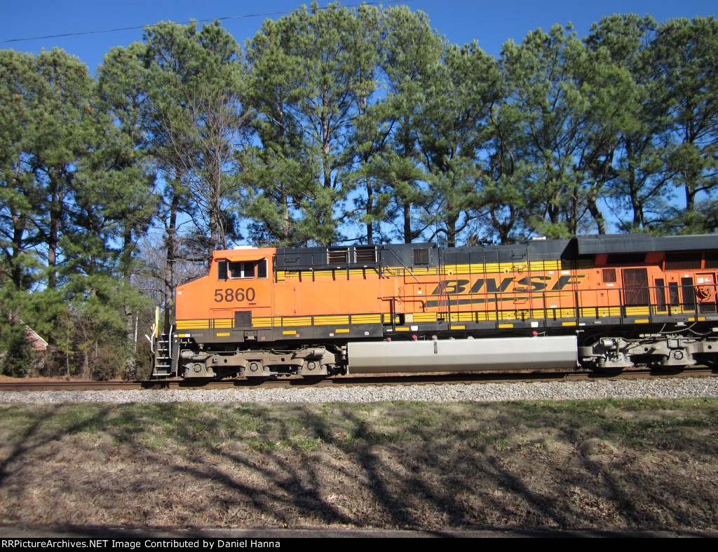 BNSF 5860 passes some pines